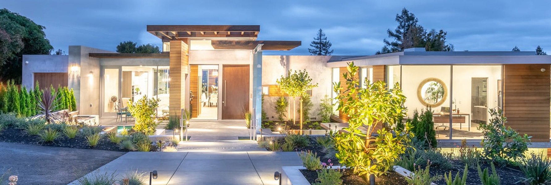 the exterior of a contemporary home with floor-to-ceiling windows and ...