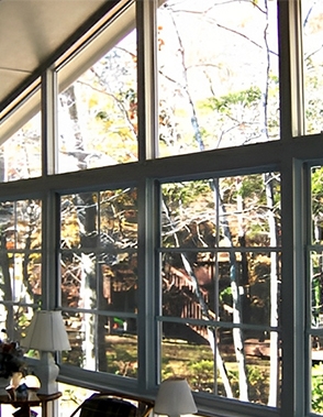vertical sliding windows on a coastal and rustic sunroom