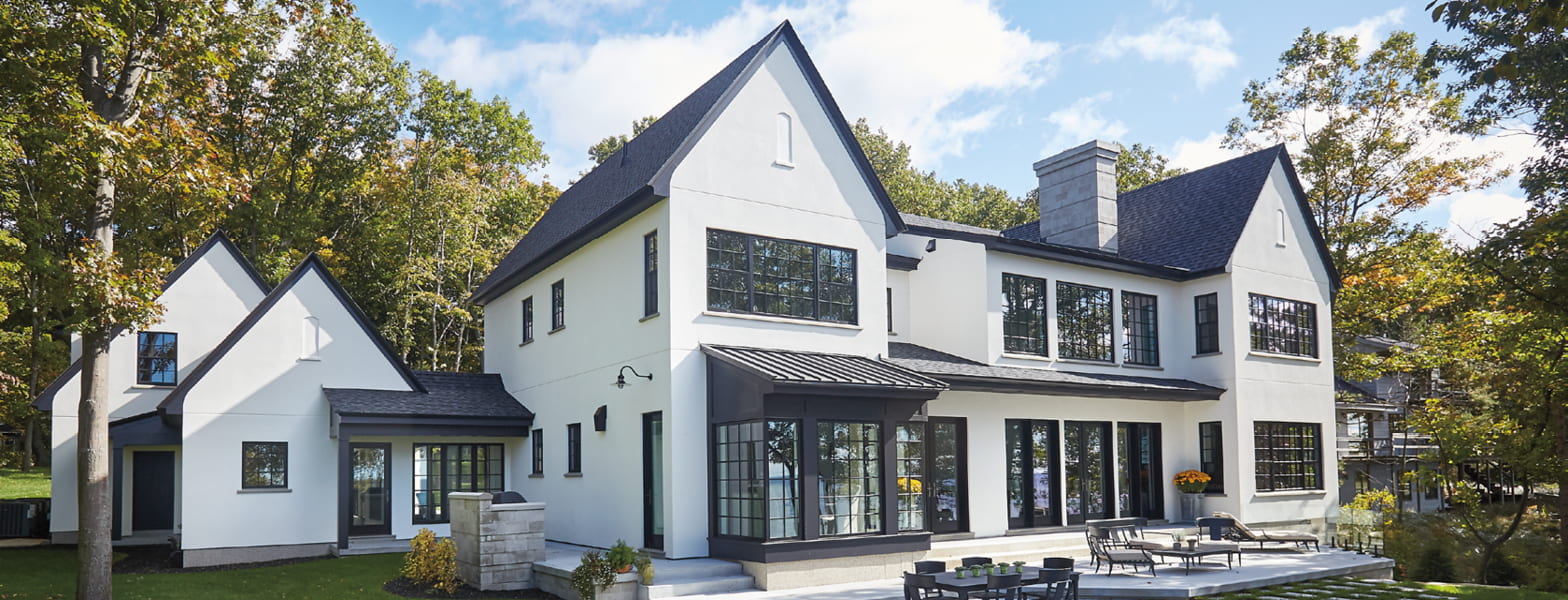 A white contemporary home as viewed from the exterior back