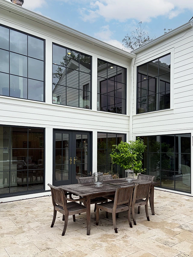 white-siding-large-windows-patio.webp